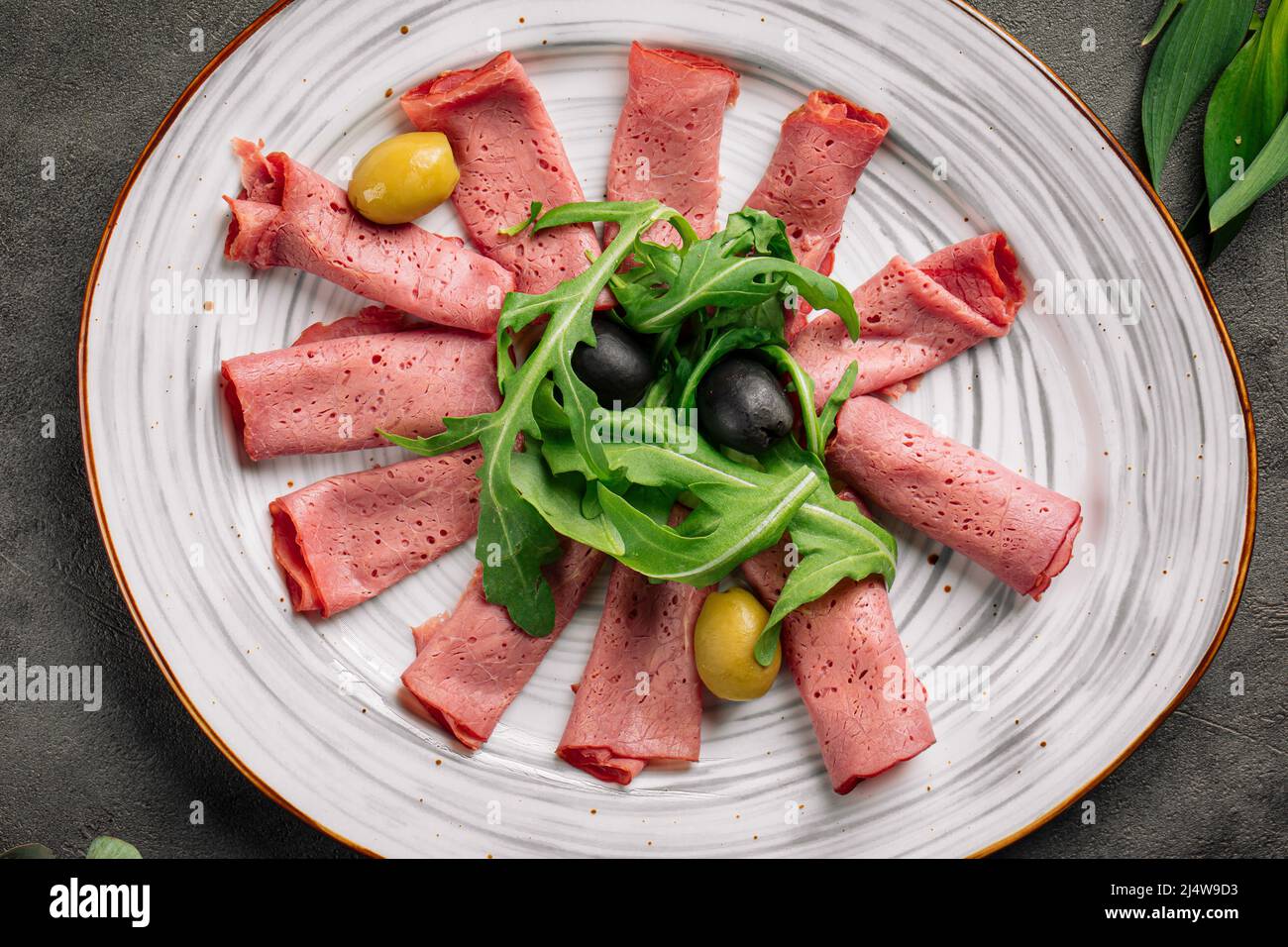 Dried meat slices appetizer platter Stock Photo - Alamy