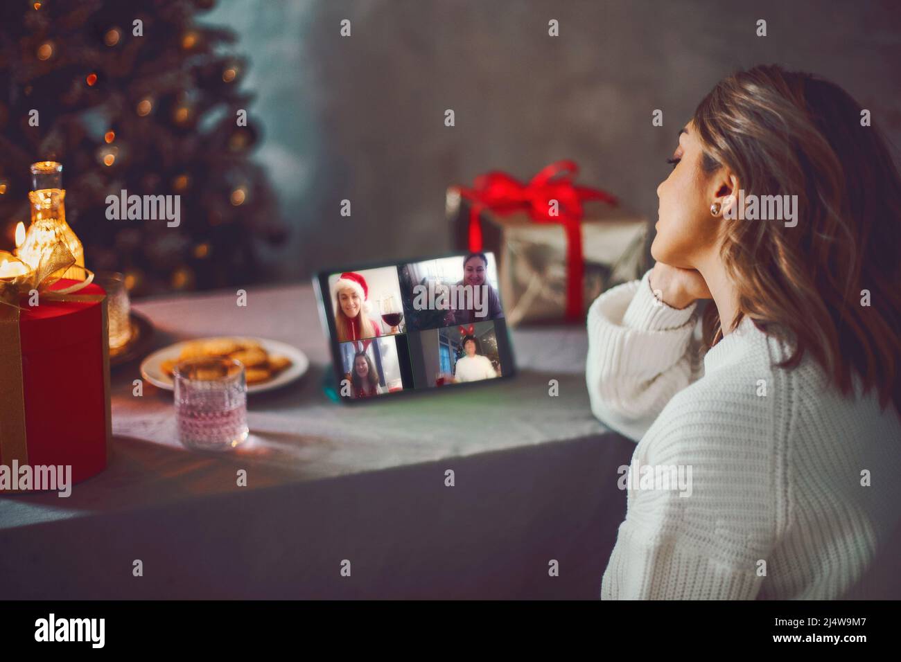 Happy young woman, drinking cocktail, talking with friends on virtual ...