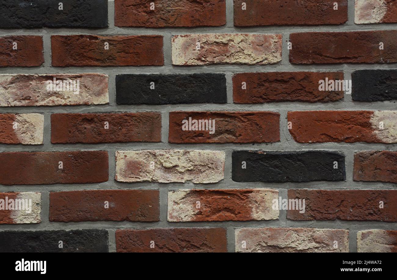 Clinker bricks background. A close-up of a clinker brick wall from dark ...
