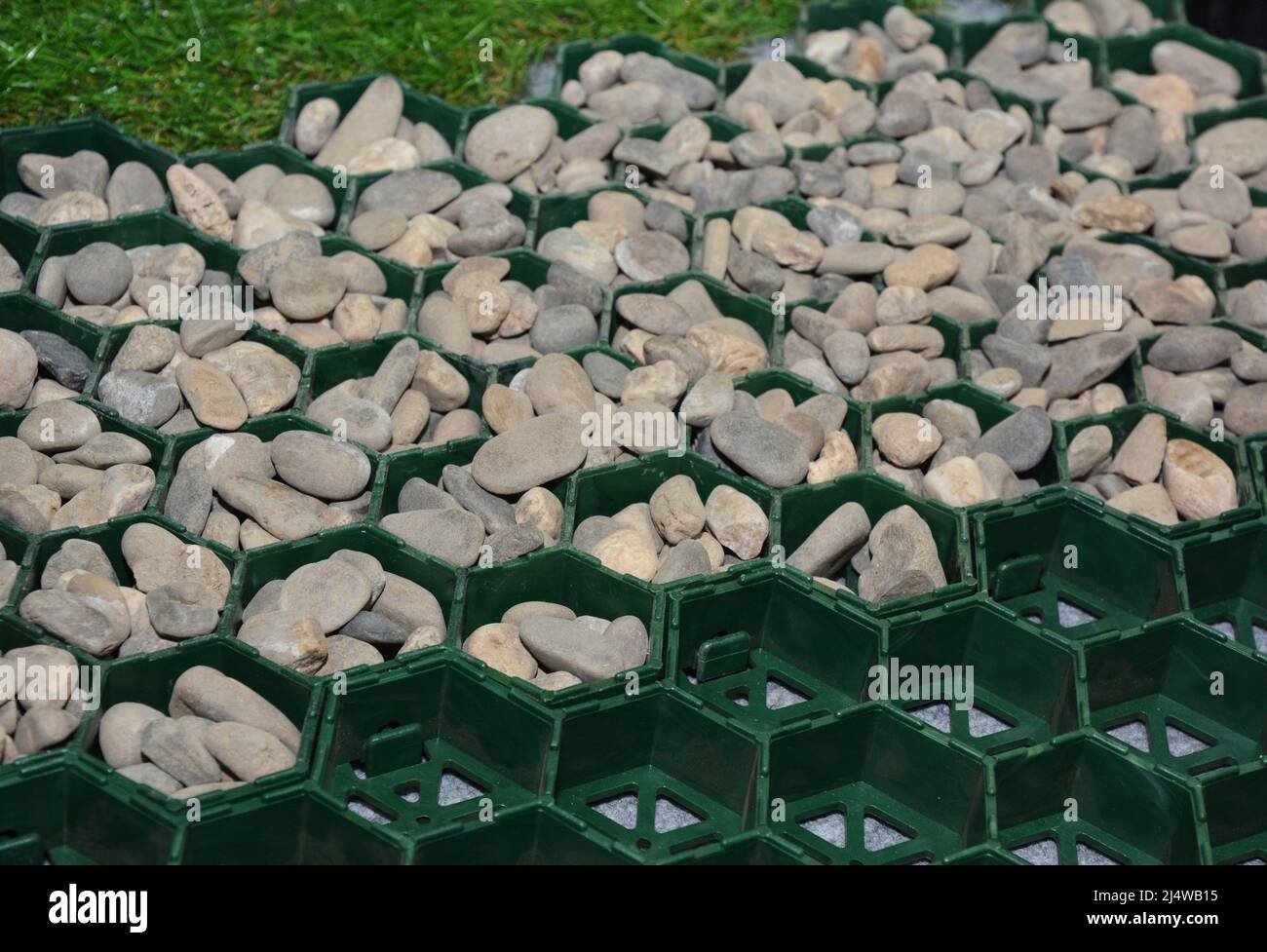A close-up of a gravel grid, a grass grid with hexagonal cells full of ...