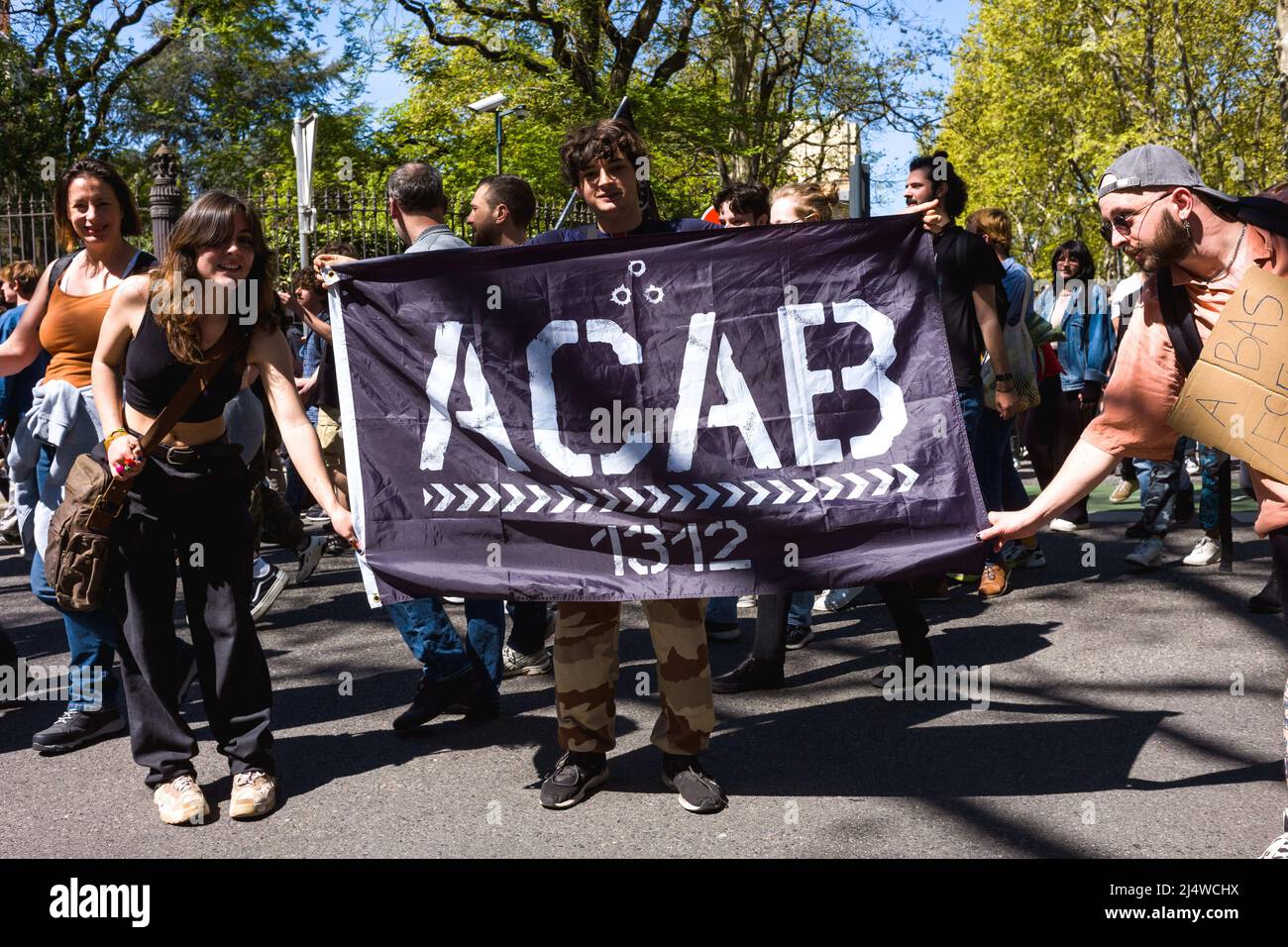 France, Toulouse, 2022-04-17. Three young men hold a flag, ACAB 1312 ...