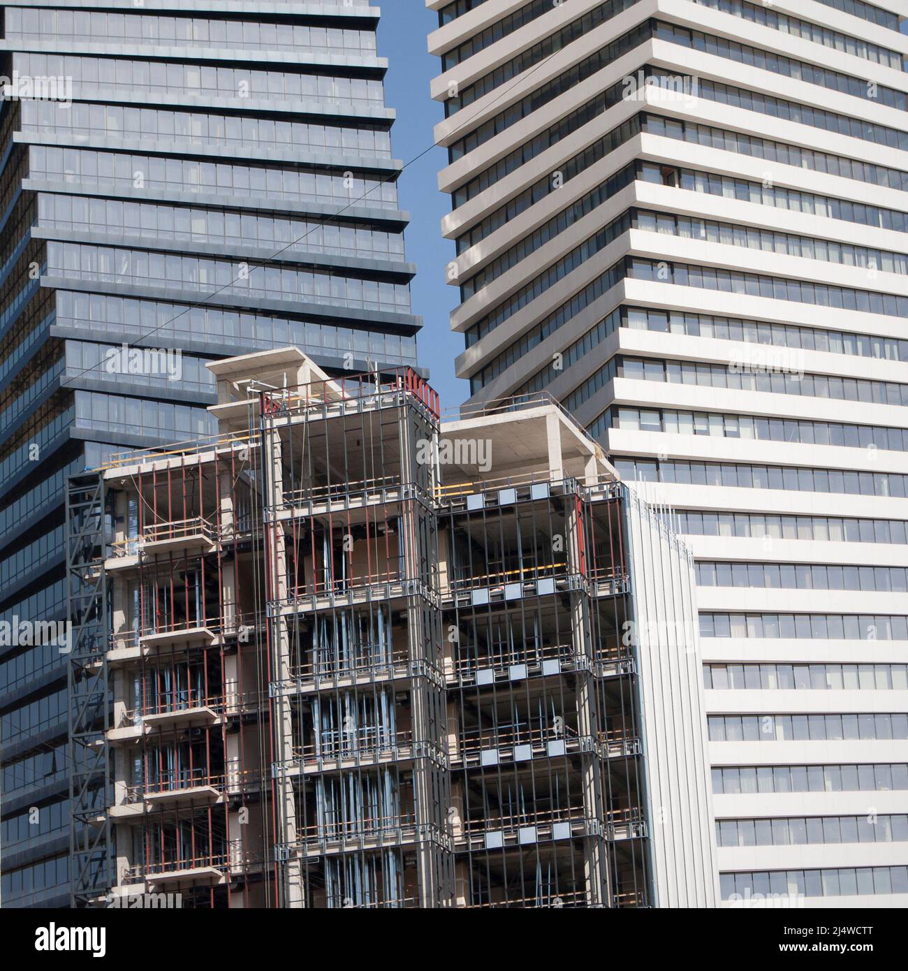 Modern multistory buildings under construction. Unfinished skyscrapers ...