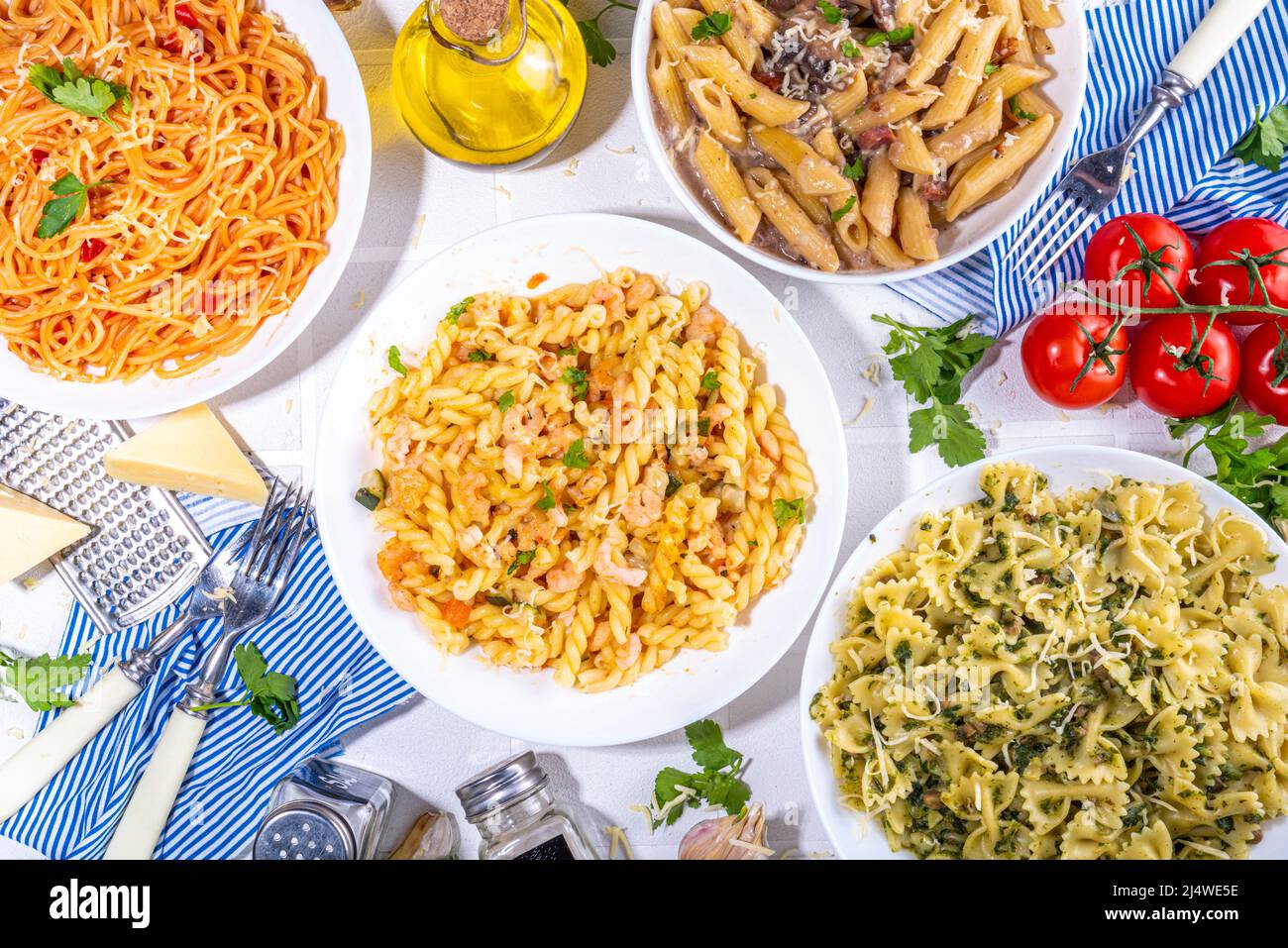 Set of pasta with different sauces on white tiled background. Spaghetti ...
