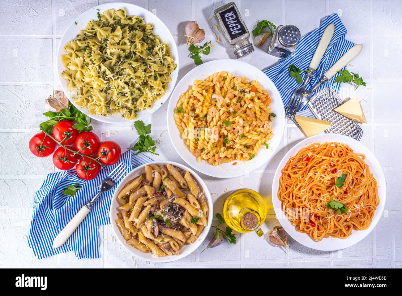 Set of pasta with different sauces on white tiled background. Spaghetti ...
