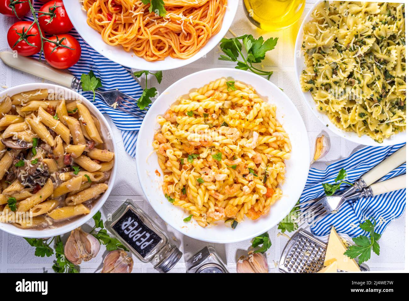 Set of pasta with different sauces on white tiled background. Spaghetti ...