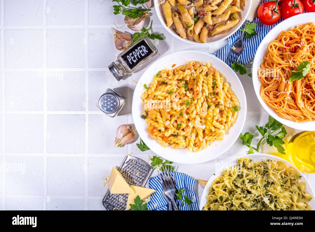 Set of pasta with different sauces on white tiled background. Spaghetti ...