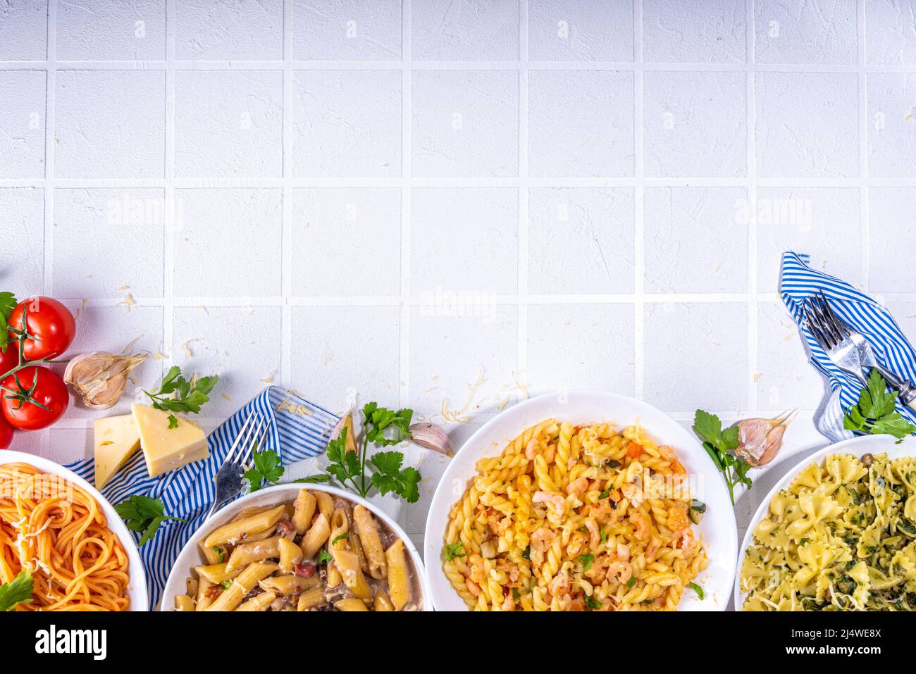 Set of pasta with different sauces on white tiled background. Spaghetti ...