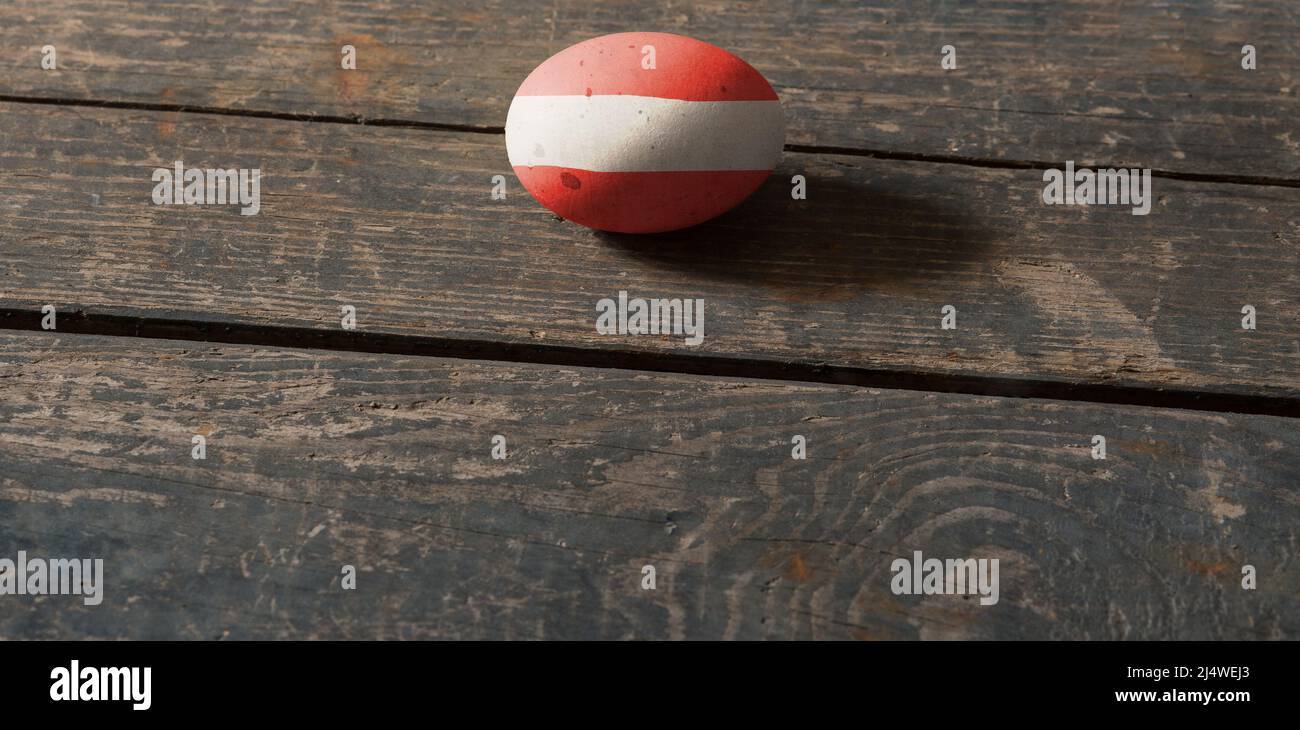 Flag of Austria on a painted egg on a wooden board. Easter in Ukraine ...