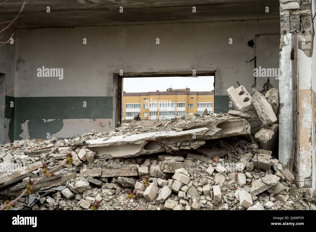 View through the destroyed window of residential buildings with a bunch ...