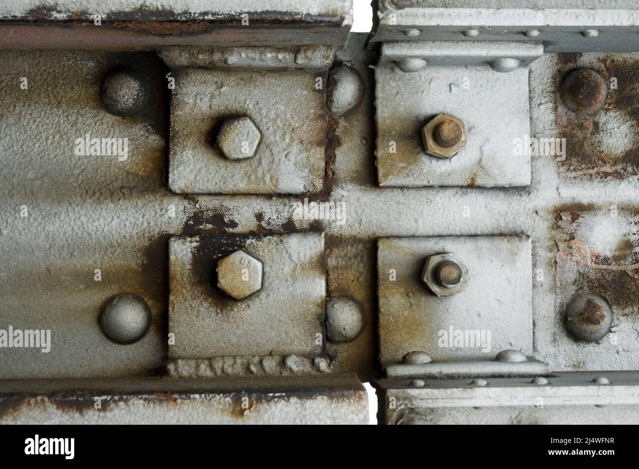 the junction of steel plates with rivets and hexagonal screws at an old ...