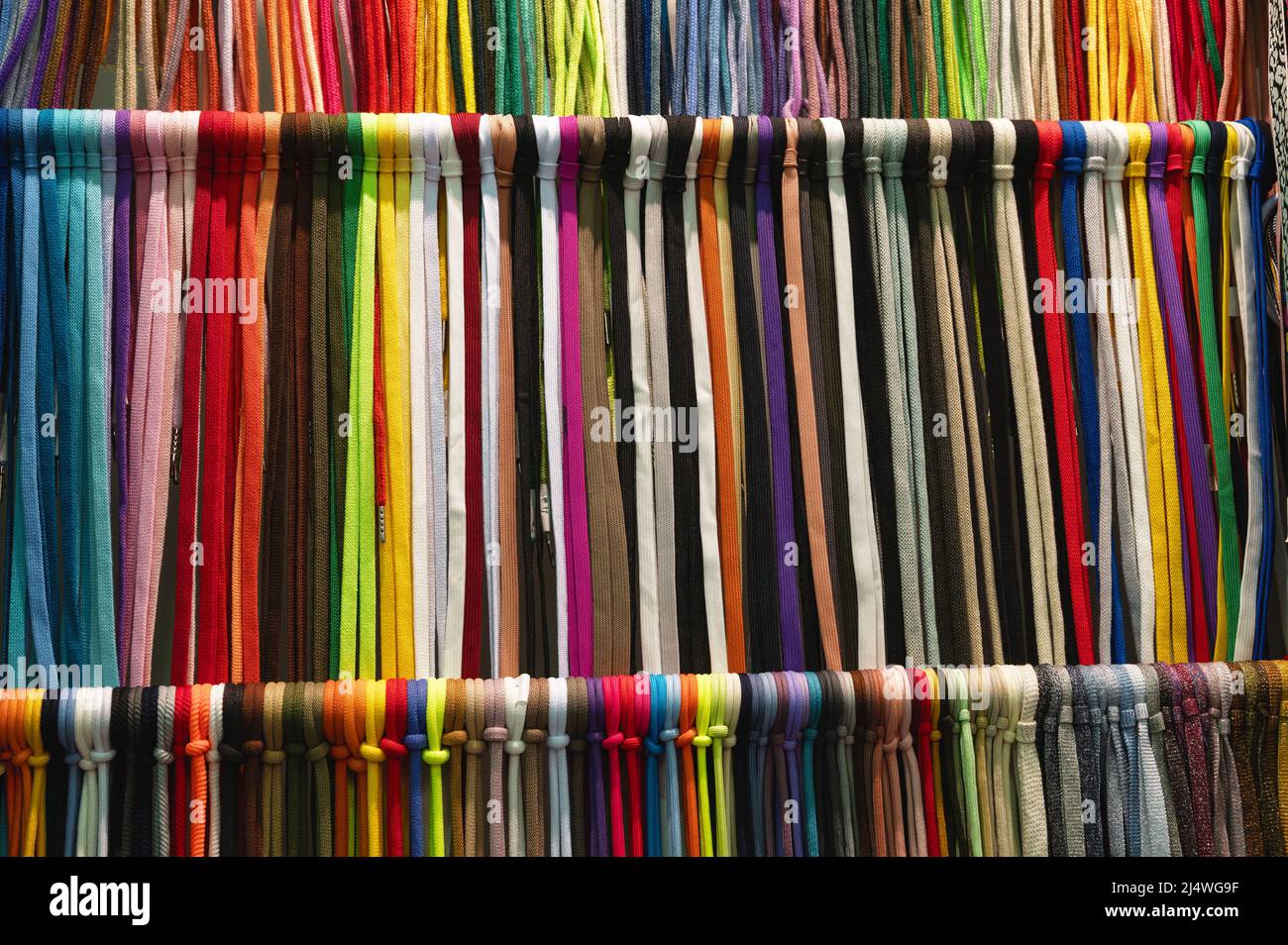 Collection of colorful lace samples hangs tied on rack bar Stock Photo ...