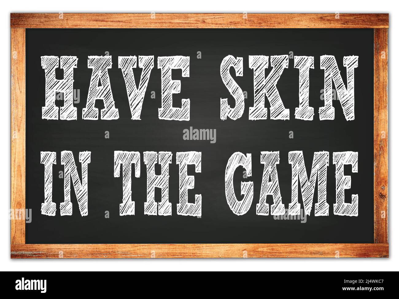 HAVE SKIN IN THE GAME written on black wooden frame school blackboard ...
