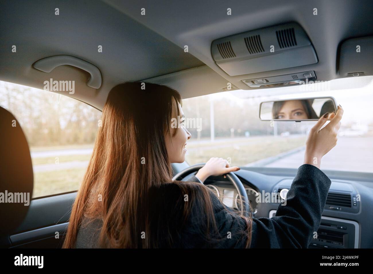 Woman driving reversing car looking hi-res stock photography and images ...