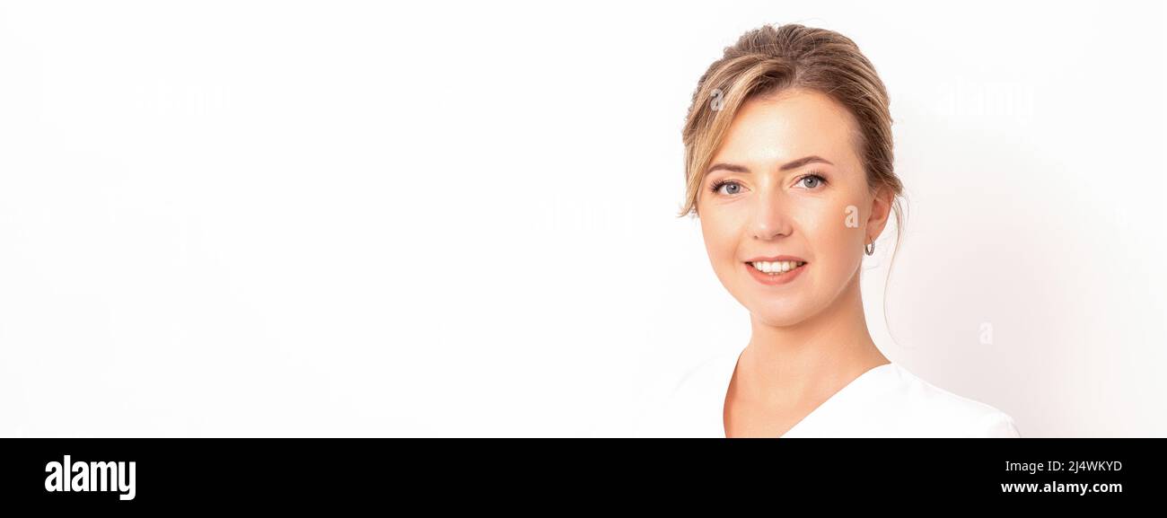 Close-up portrait of young smiling female caucasian healthcare worker ...