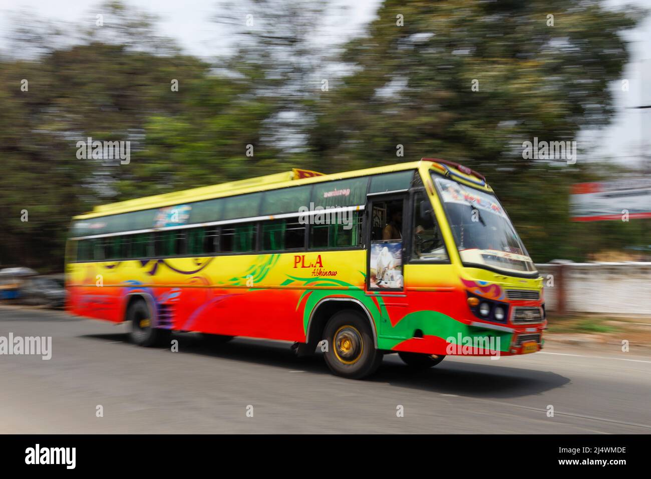 Modern long distance bus travelling in the street,Trichy, Tamil Nadu ...