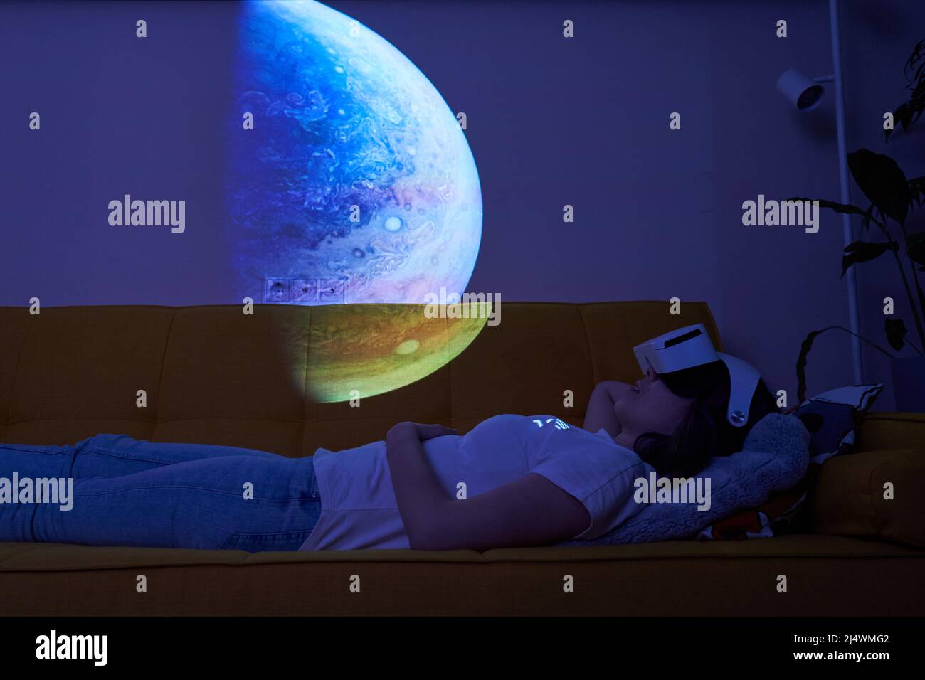 Woman uses virtual reality glasses to see the galaxy space. Elements of ...