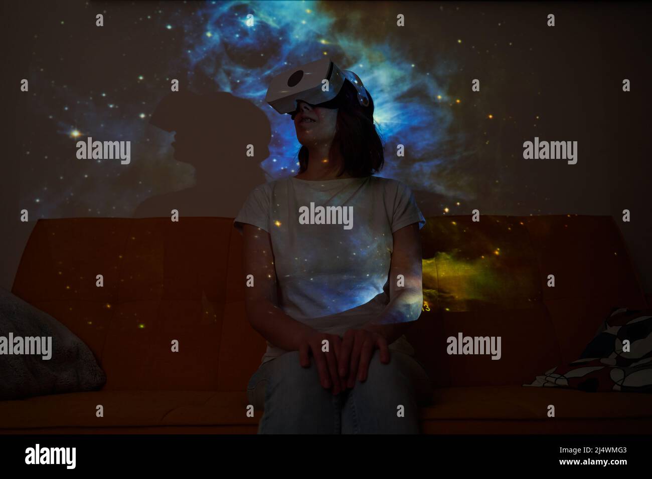 Woman uses virtual reality glasses to see the galaxy space. Elements of ...
