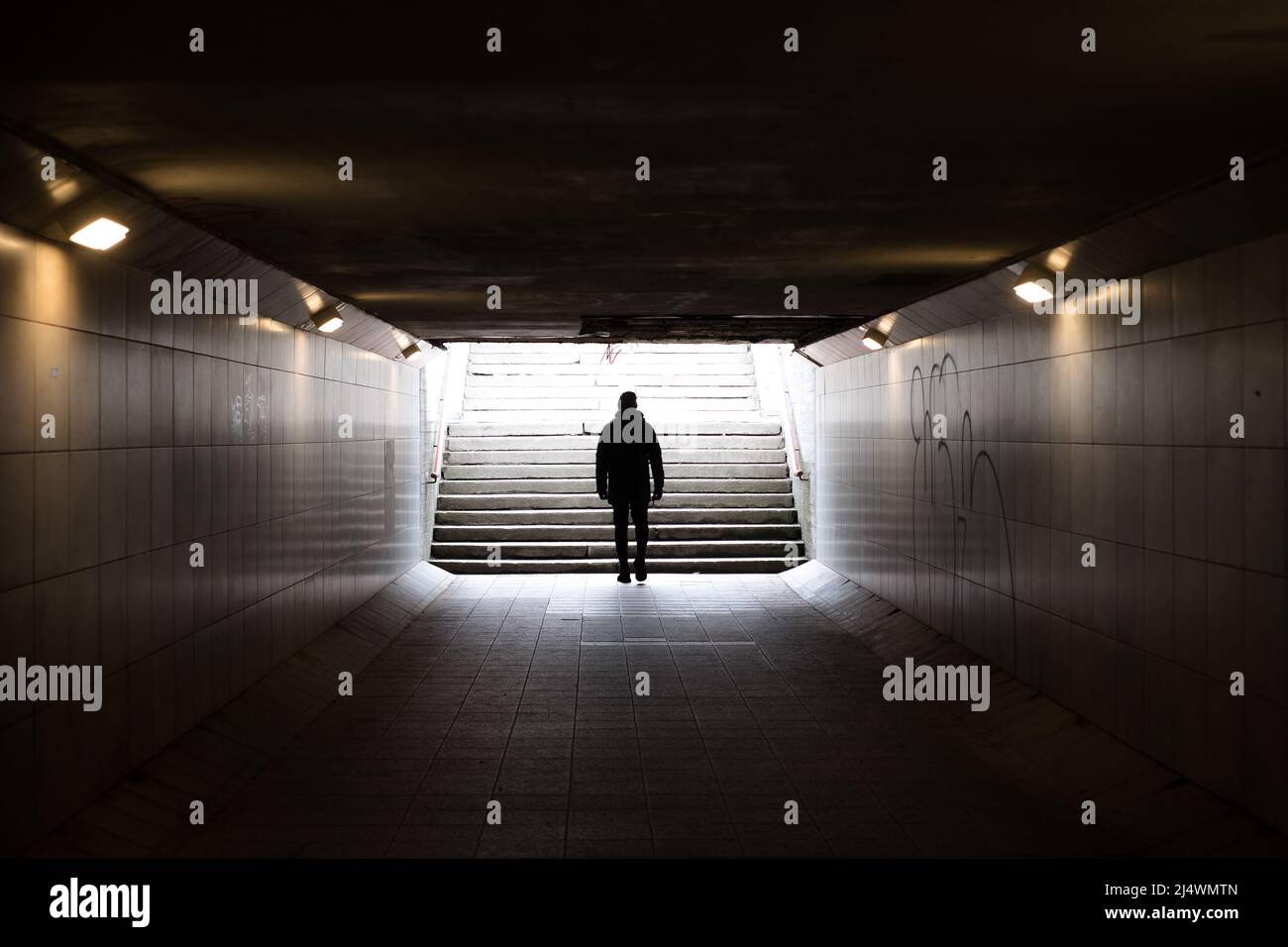 Man walking in dark underground tunnel. Stranger anonymous person Stock ...