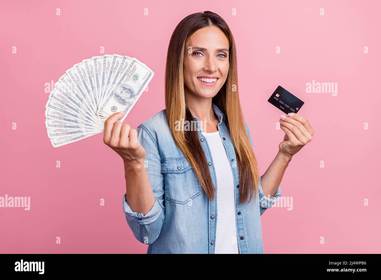 Photo of young cheerful woman hold dollars cash bank card income ...