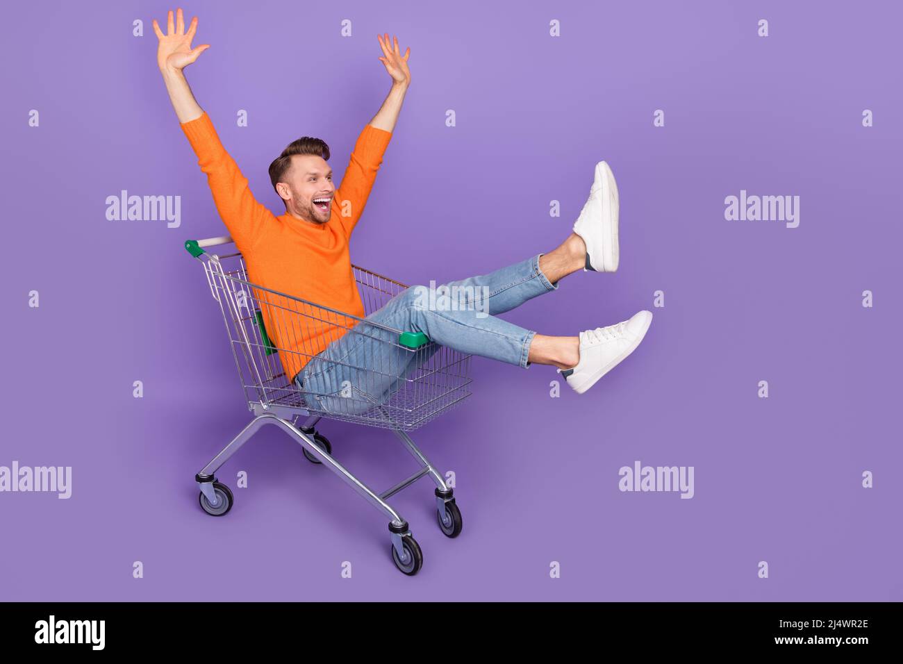 Full length photo of cheerful overjoyed laughing man riding in trolley ...