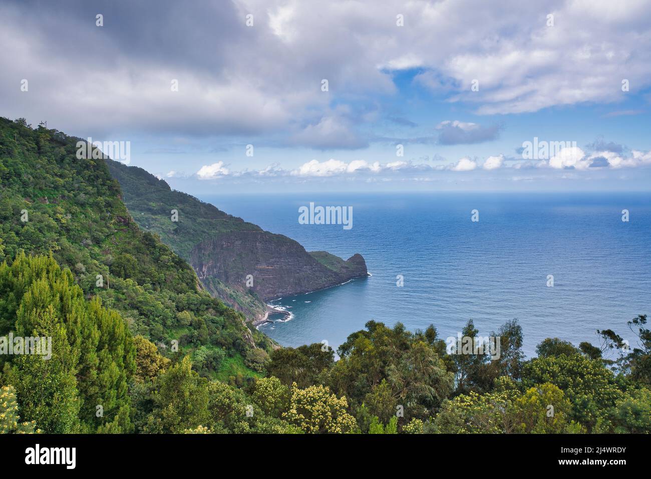A beautiful scenic view of the coast and mountains of Madeira. Clouds ...