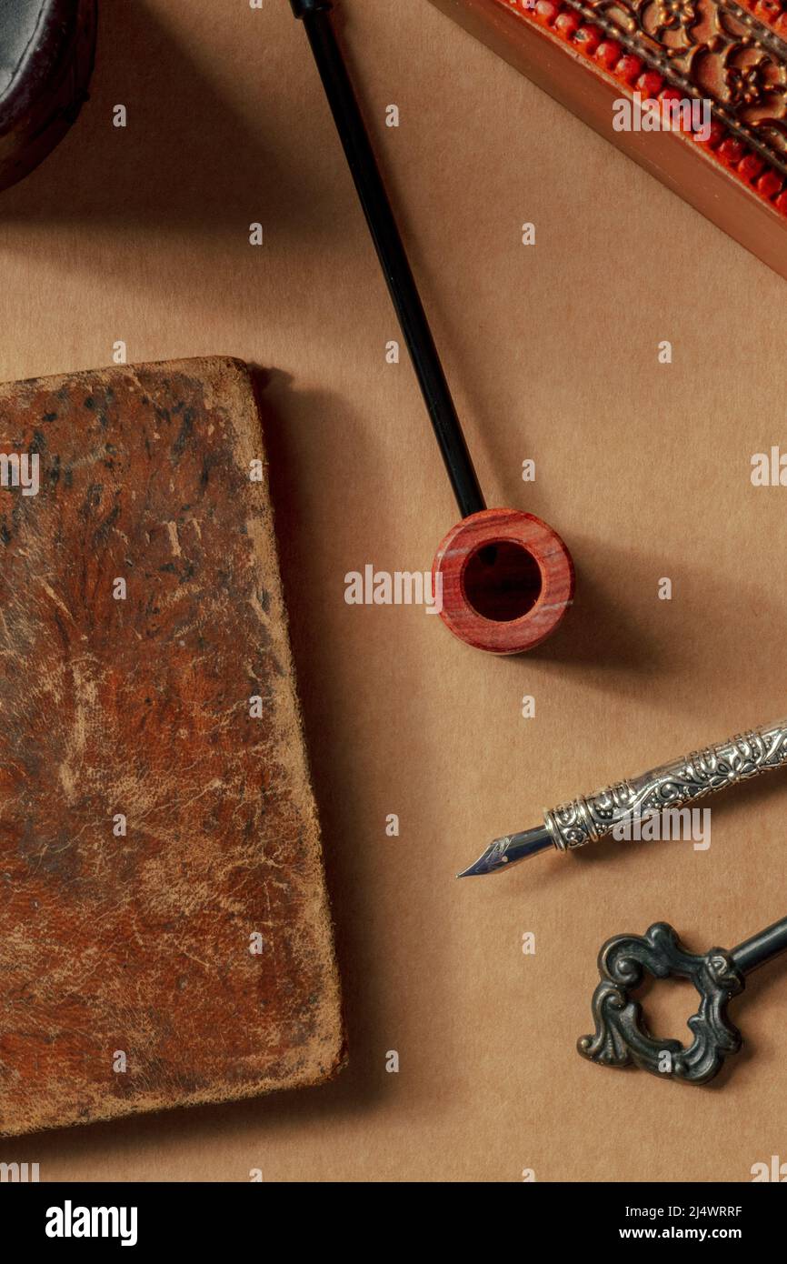 A vintage pipe and an old notebook, retro objects. The concept of a ...