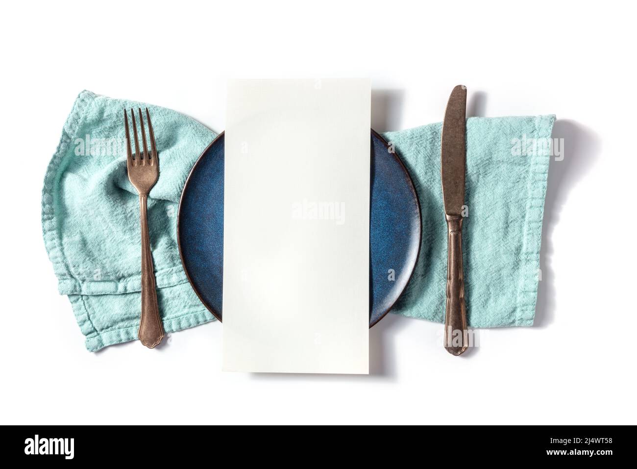 Dinner menu or invitation concept. A piece of paper on a set table ...