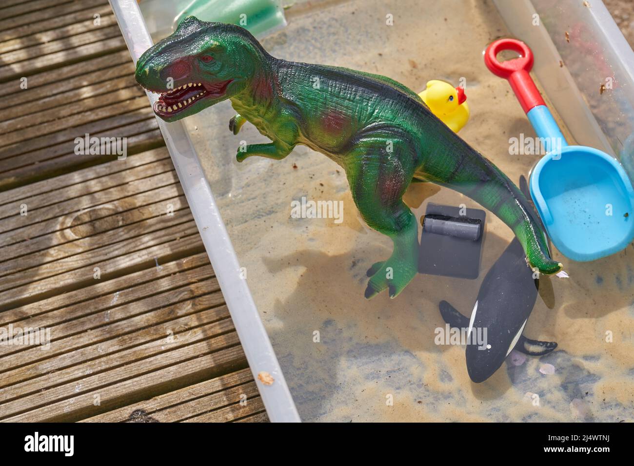 Plastic toys in a tub of water Stock Photo - Alamy