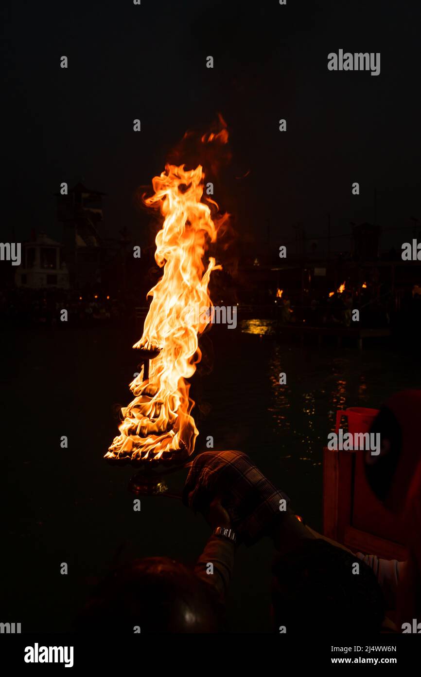 burning flame of aarti with dark background for holy rituals of ganges ...