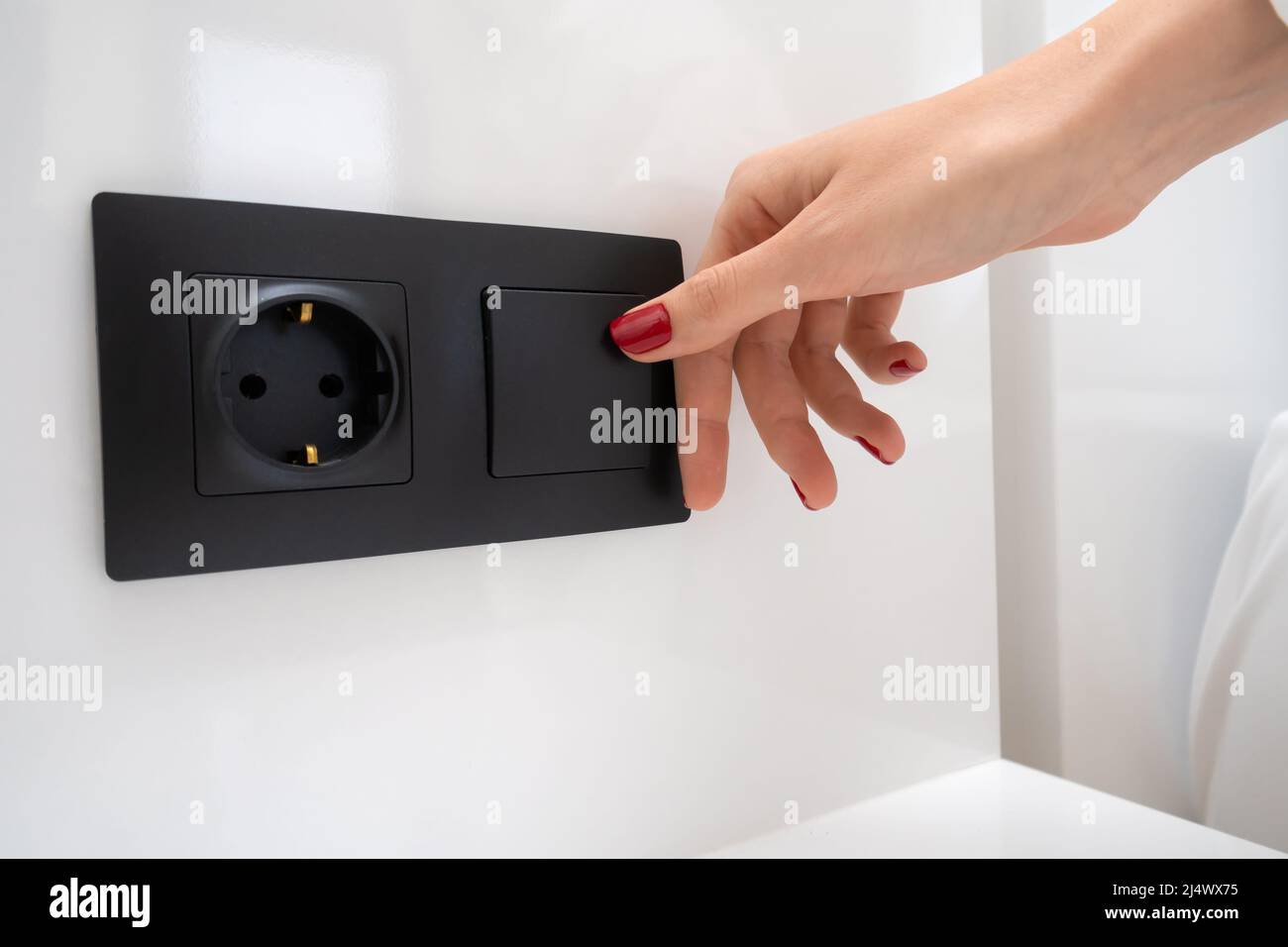 Womans hand light switch hi-res stock photography and images - Alamy