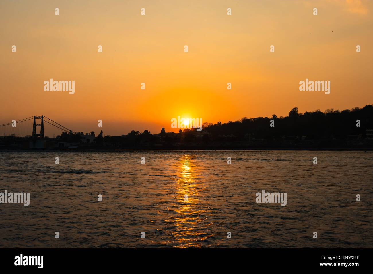 sunset orange sky over flowing river horizon at evening from flat angle ...