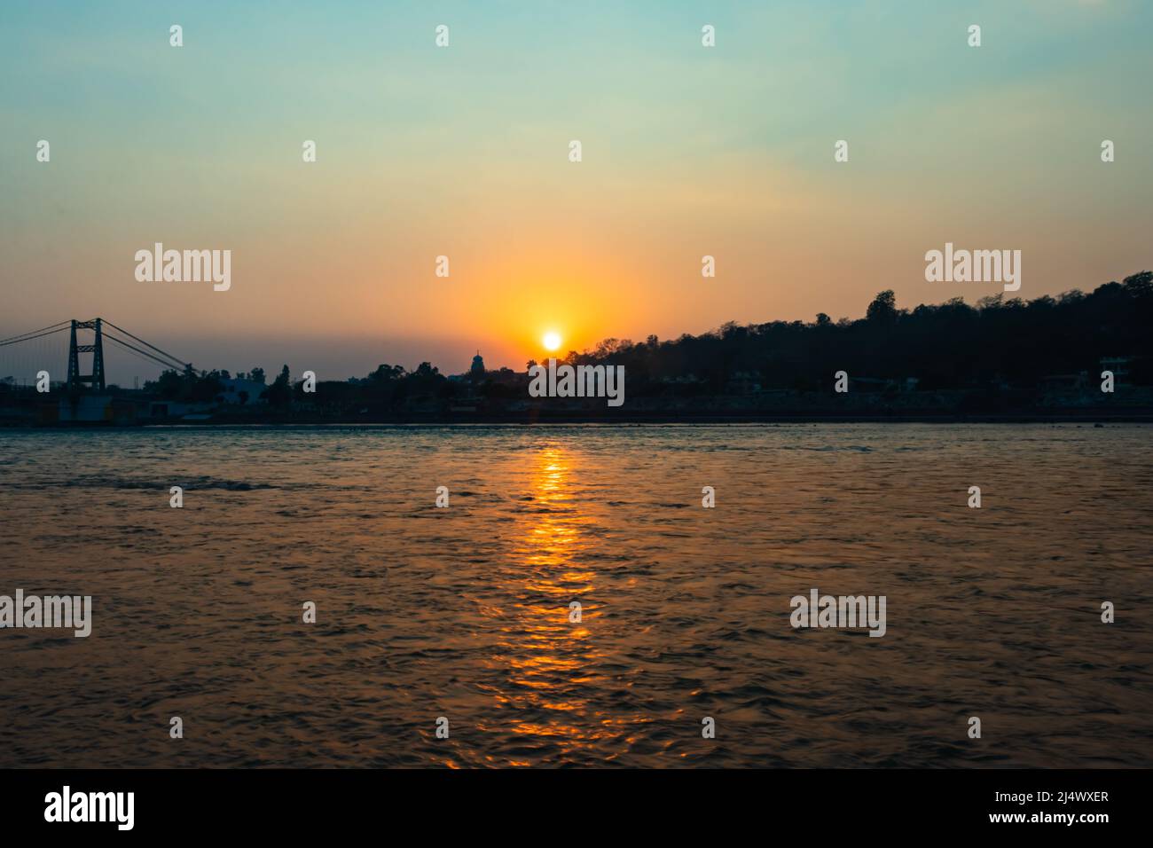 sunset orange sky over flowing river horizon at evening from flat angle ...