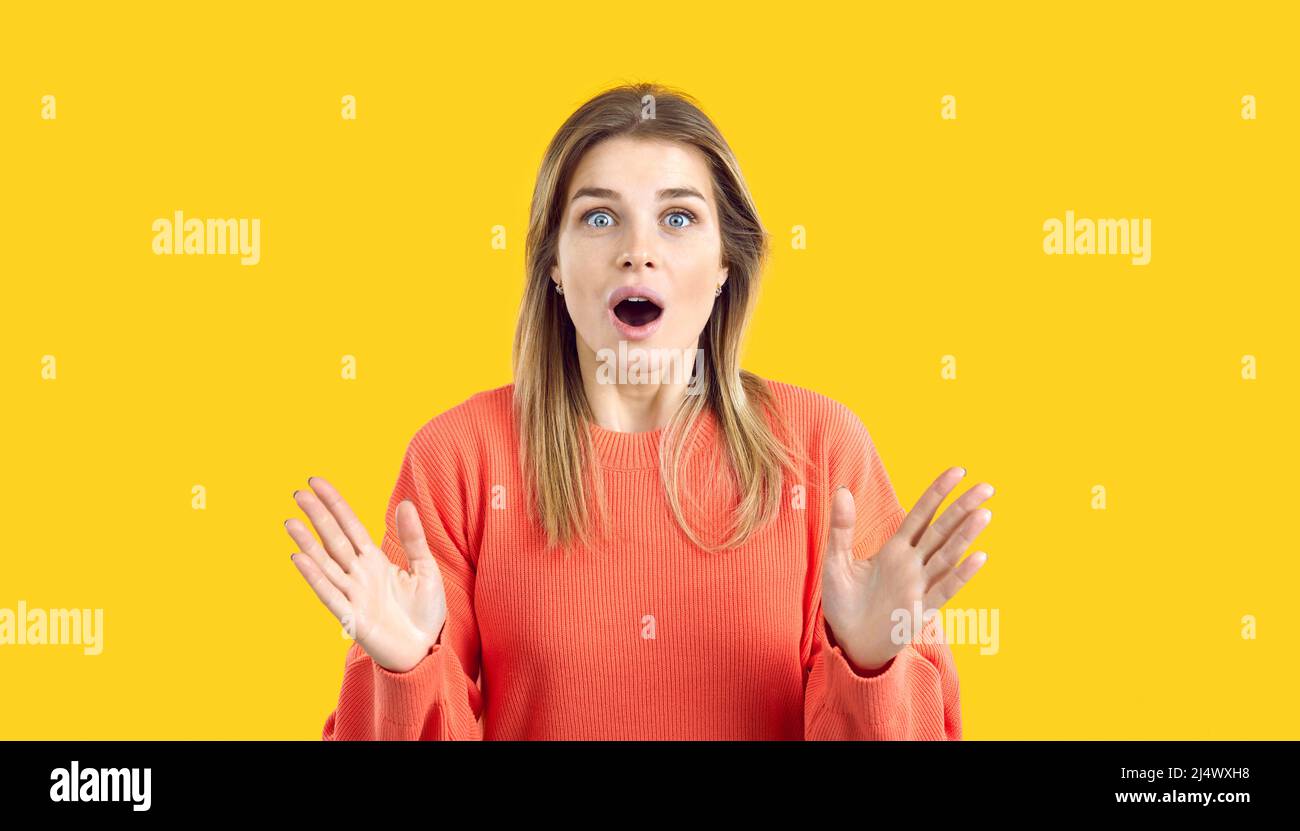 Portrait of surprised and amazed young woman looking at you with wide ...