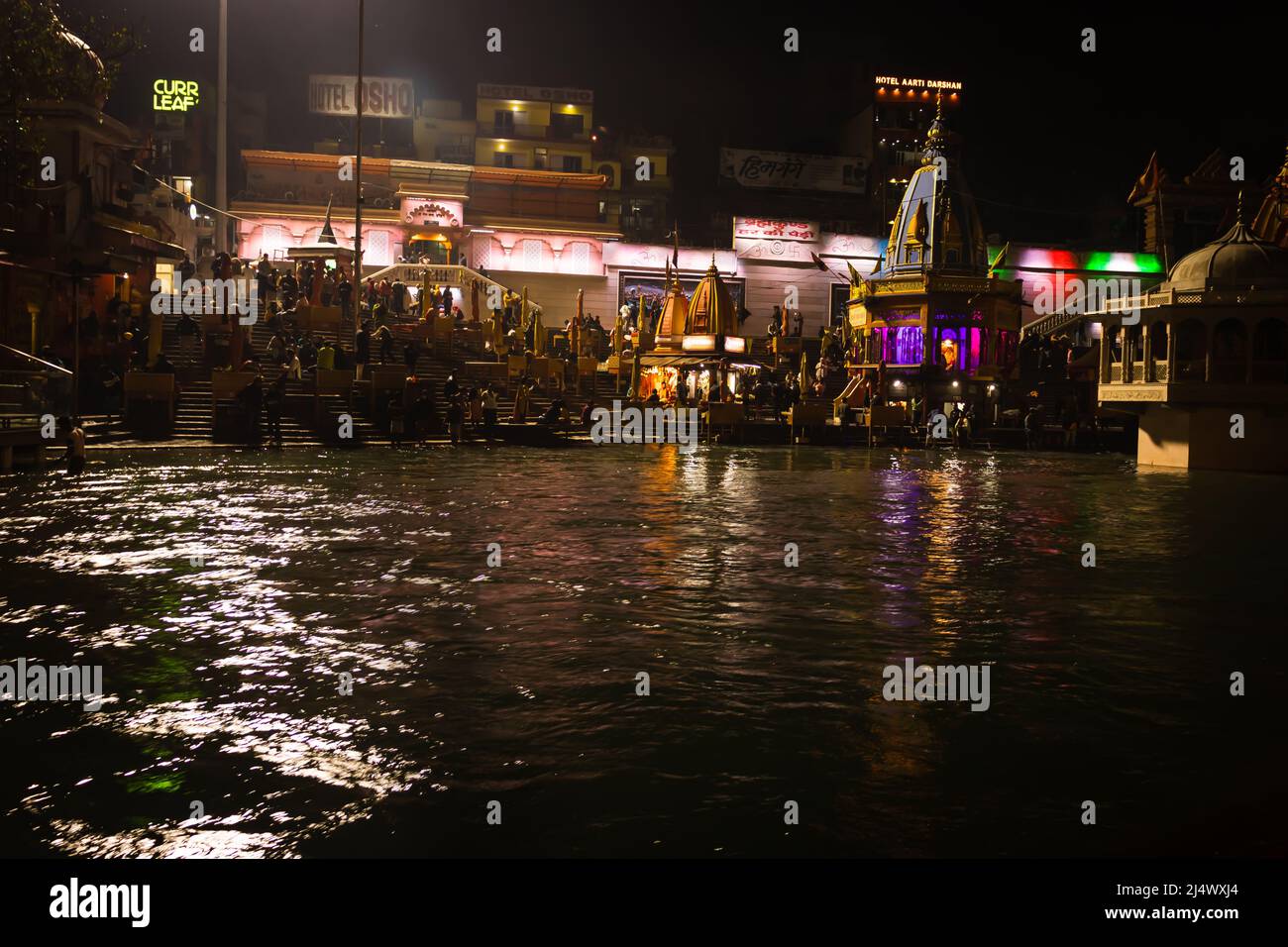 holy ganges aarti flame with crowed shadow at evening at riverbank ...