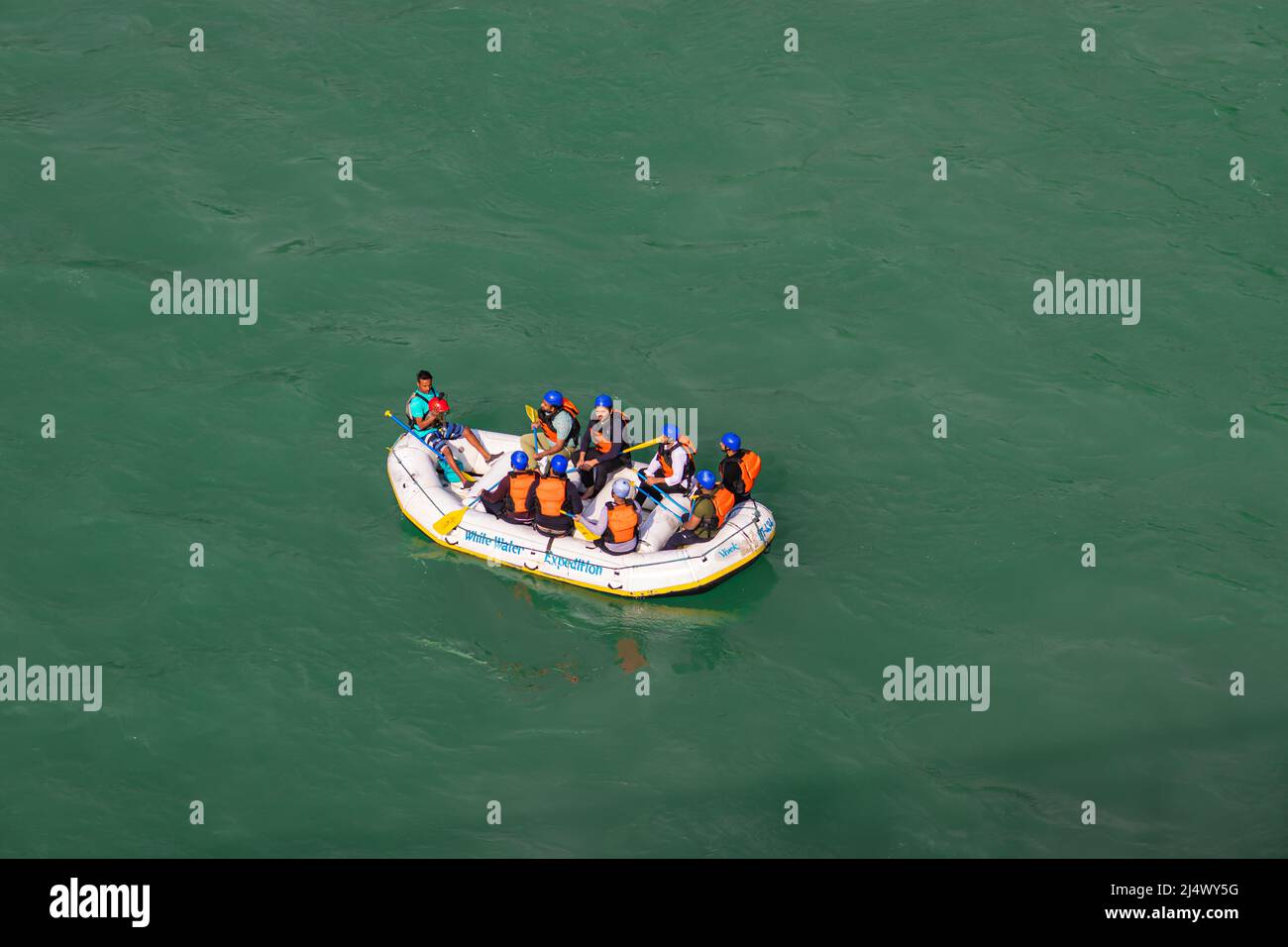 raft boat with people at the middle of ganges river from top angle ...