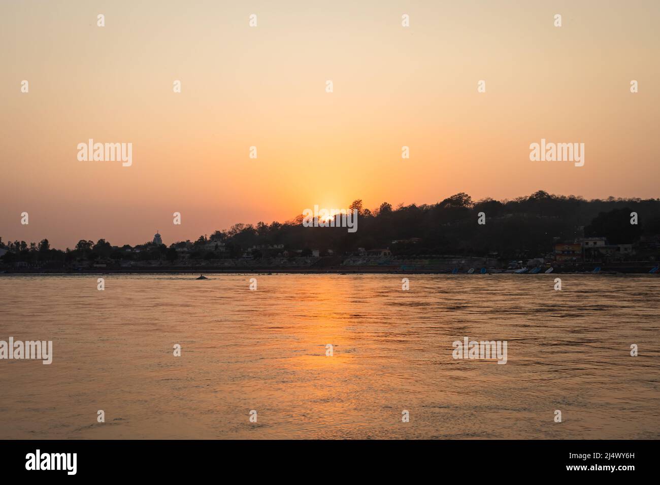 sunset dramatic orange sky over river horizon at evening from flat ...
