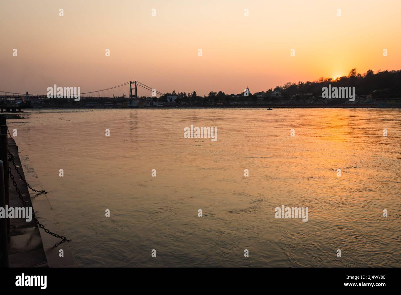 sunset orange sky over flowing river horizon at evening from flat angle ...