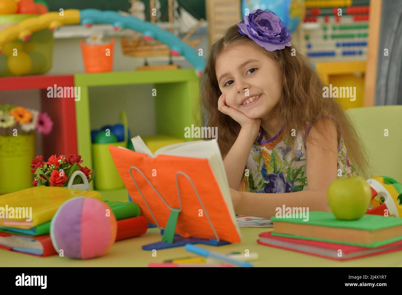 Beautiful girl doing home work at table Stock Photo - Alamy