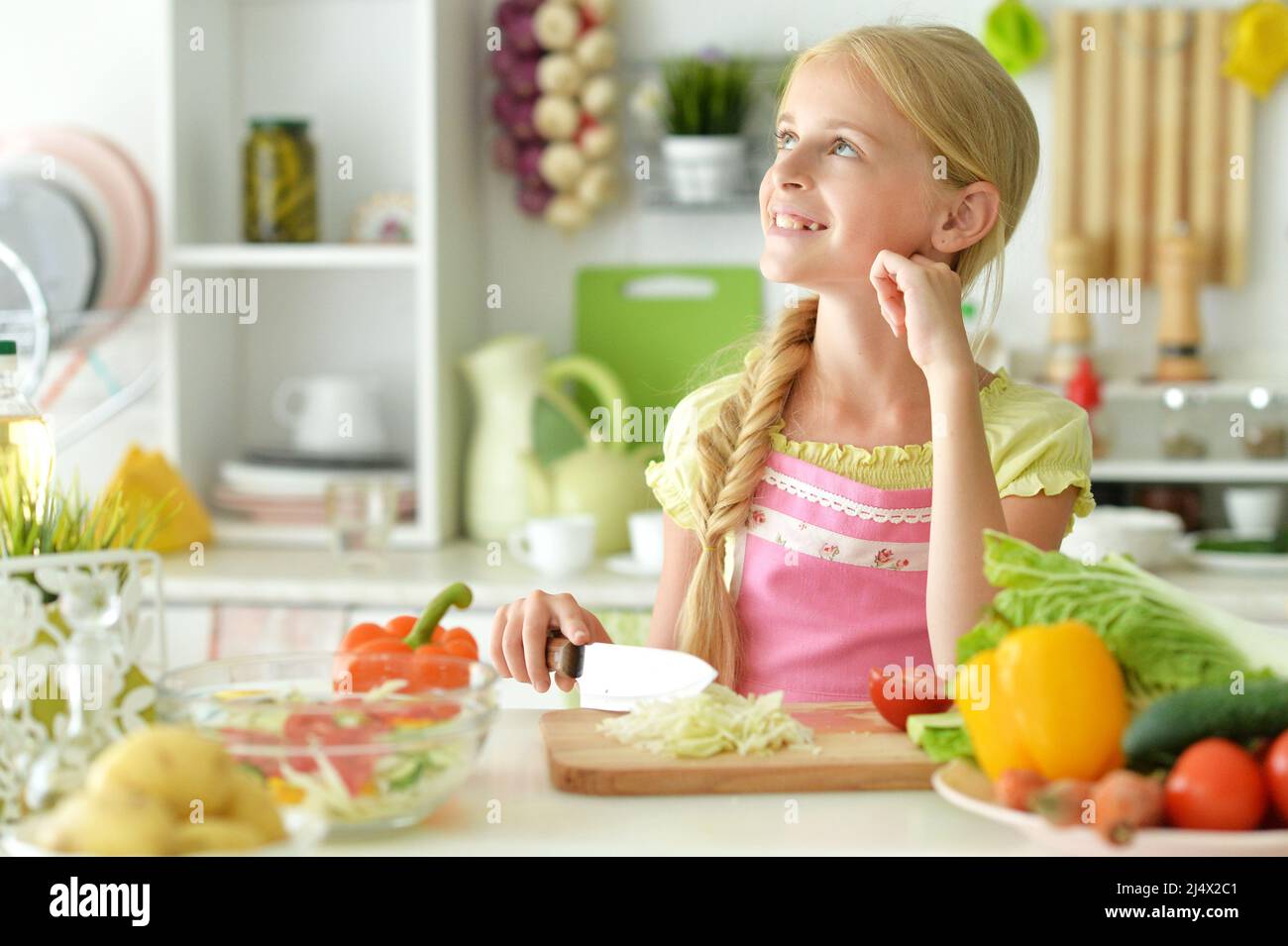 Portrait of cute girl cooking on kitchen Stock Photo - Alamy