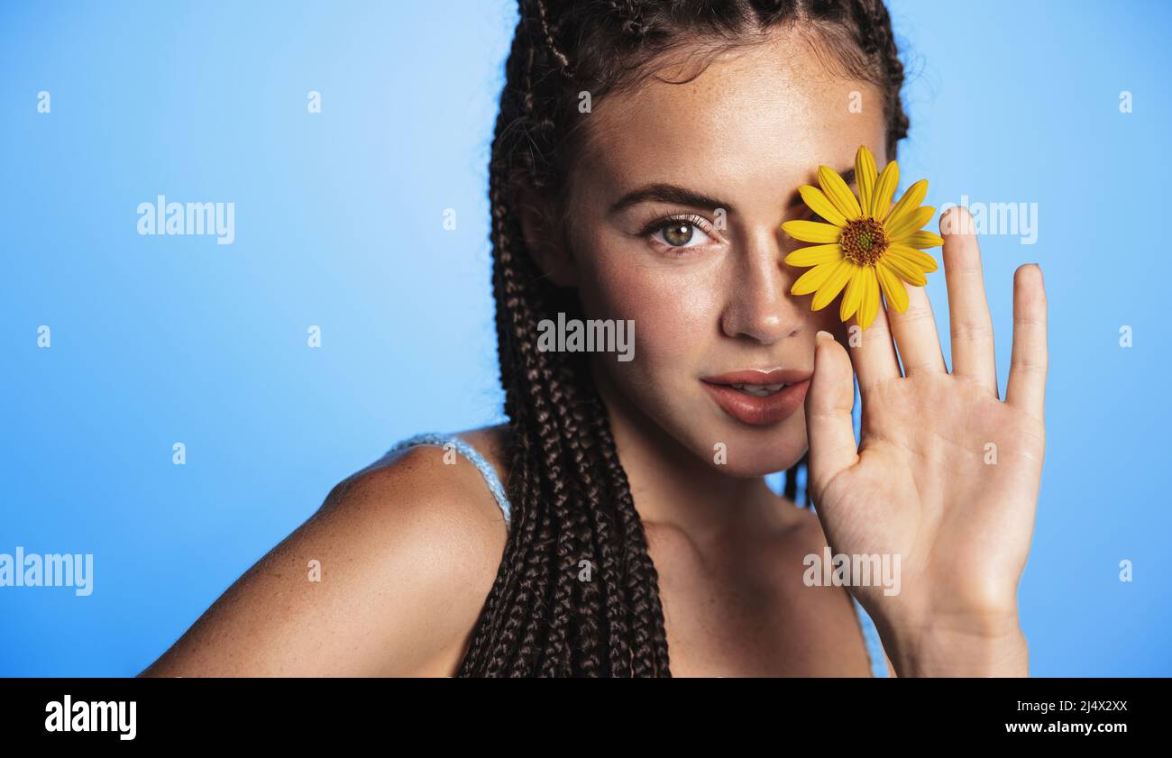 Portrait of beautiful summer girl with dreadlocks, holding yellow ...