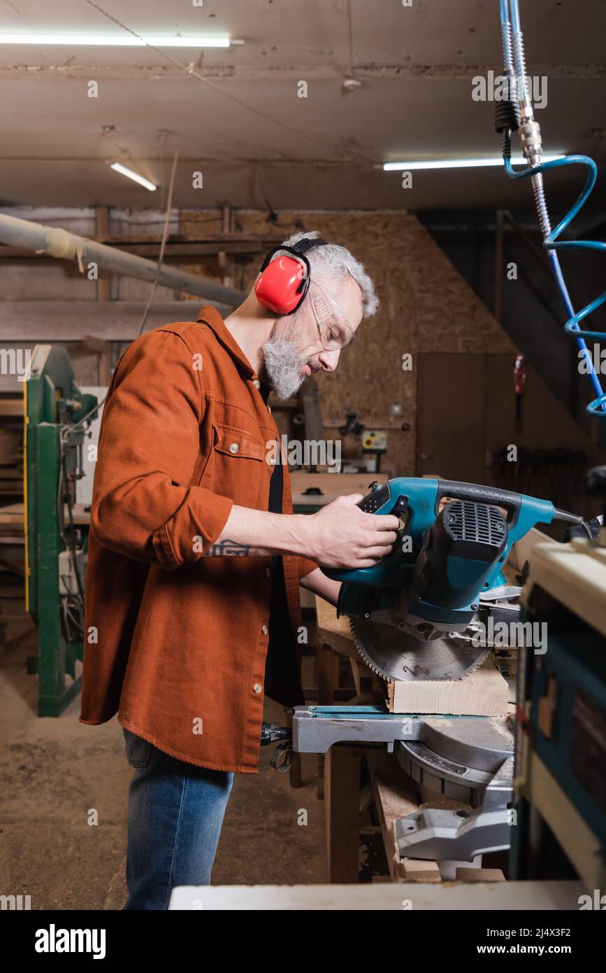 Side view professional woodworker cutting hi-res stock photography and ...