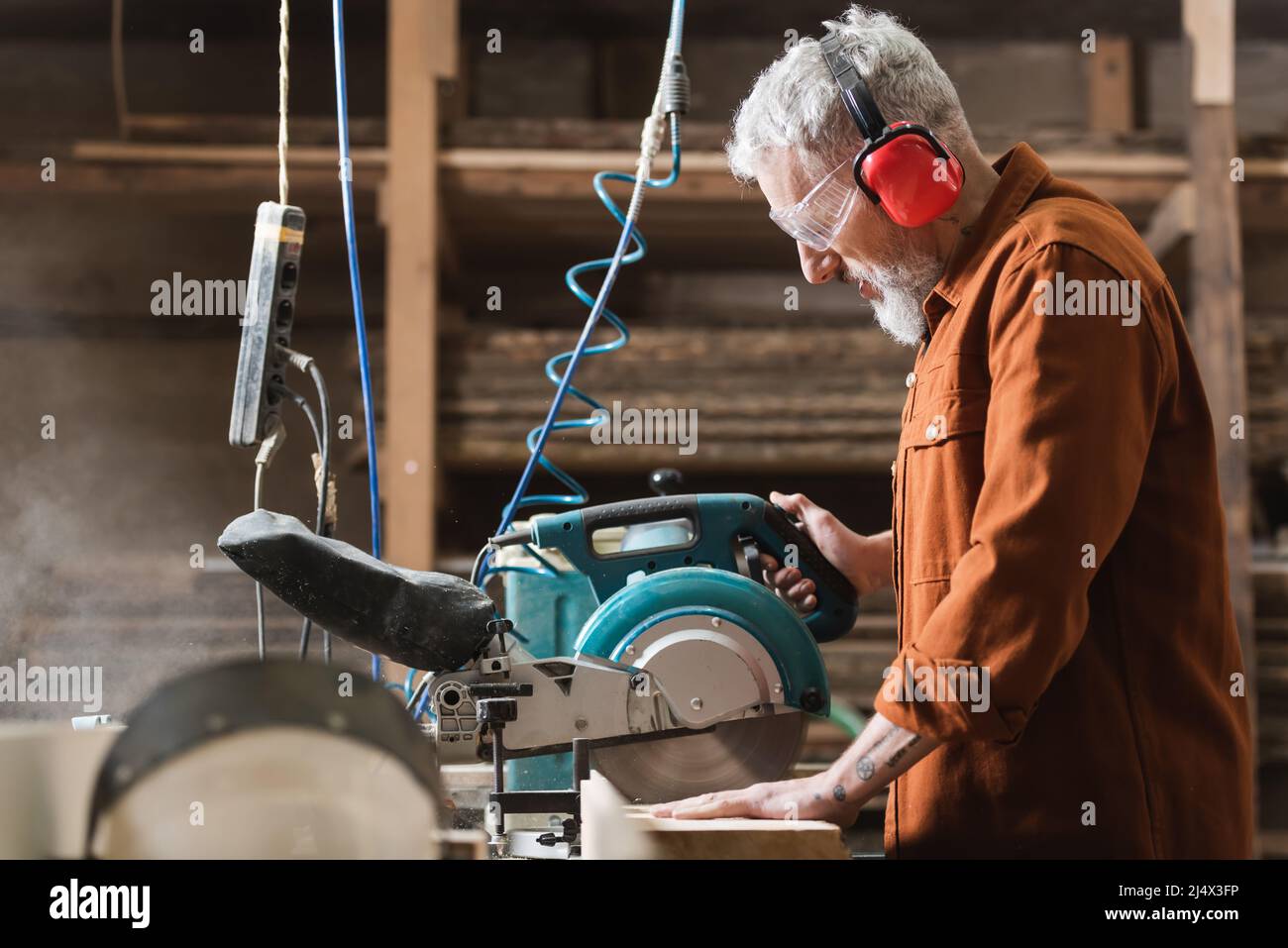Side view professional woodworker cutting hi-res stock photography and ...