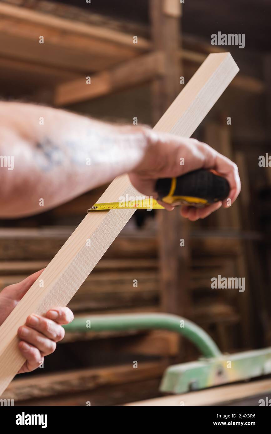partial view of furniture designer measuring wooden plank Stock Photo ...