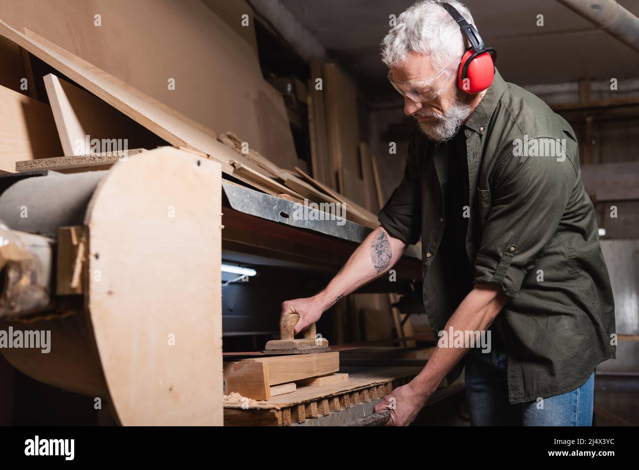 bearded woodworker polishing board in sander machine Stock Photo - Alamy