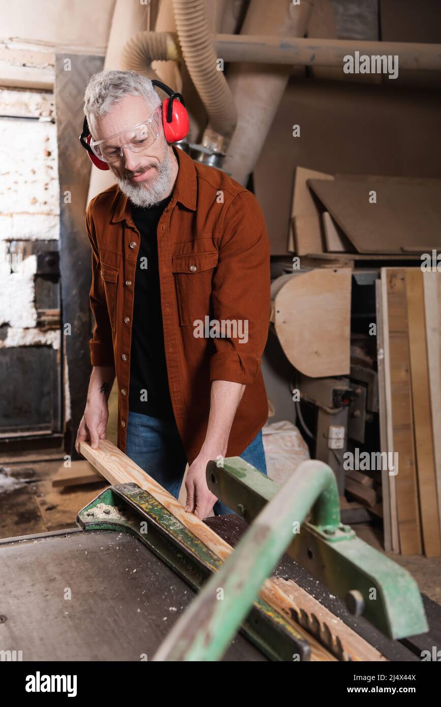 Mature carpenter in earmuffs hi-res stock photography and images - Alamy