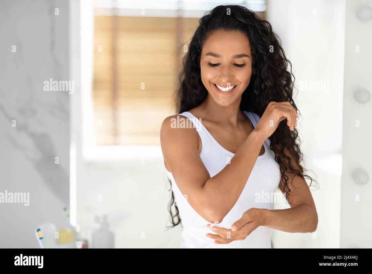 Woman moisturising elbow hi-res stock photography and images - Alamy
