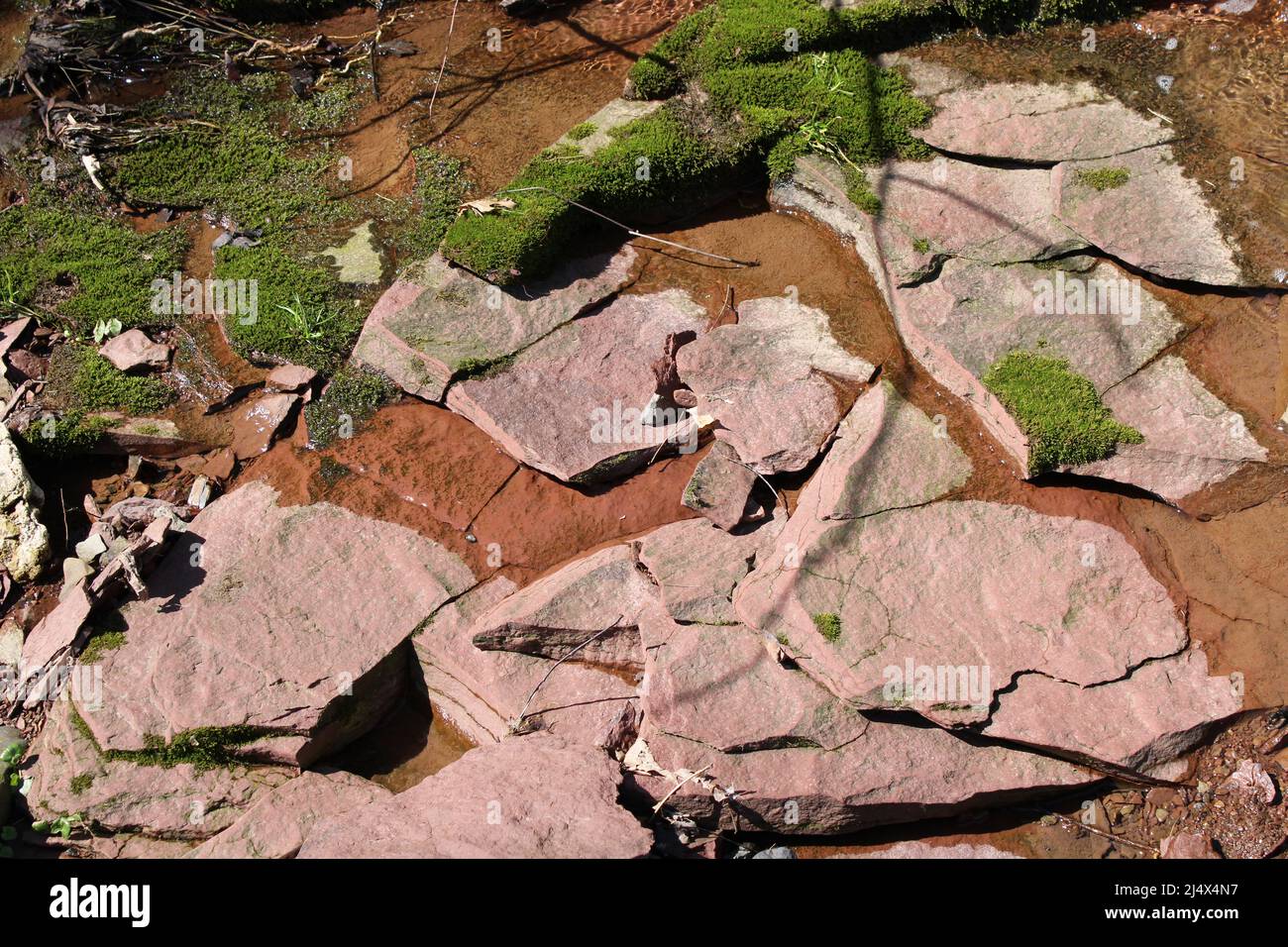 Large Red Rocks in a Creek Bed Stock Photo - Alamy