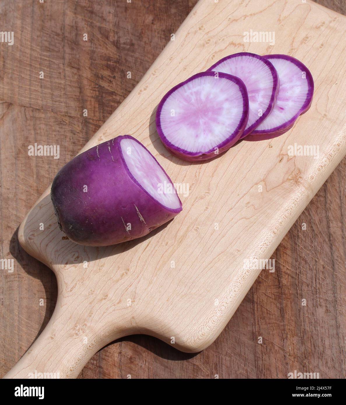 A Purple Radish Being Prepared on a Maple Cutting Board Stock Photo - Alamy