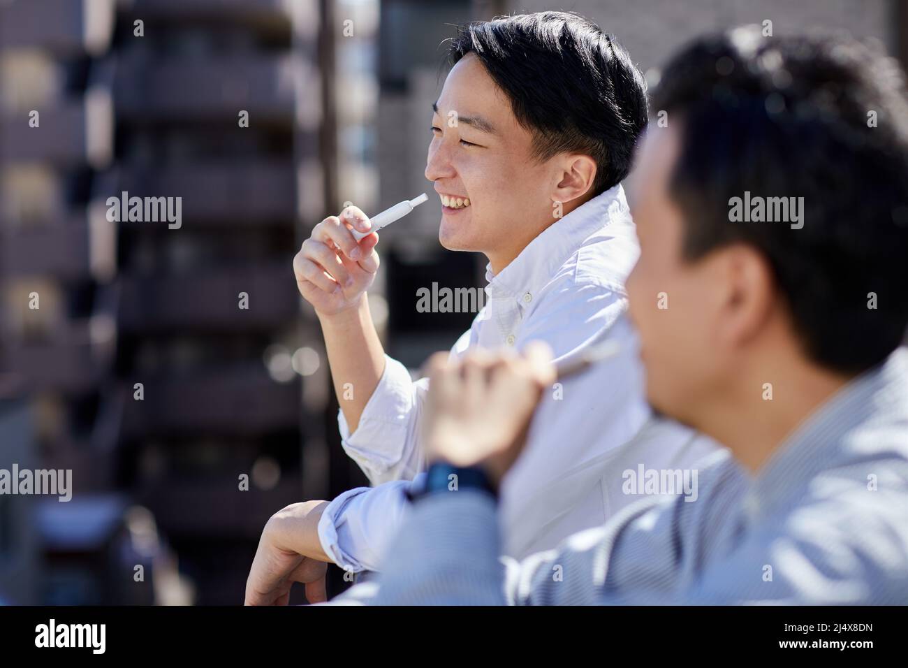 Japanese men smoking outside Stock Photo - Alamy