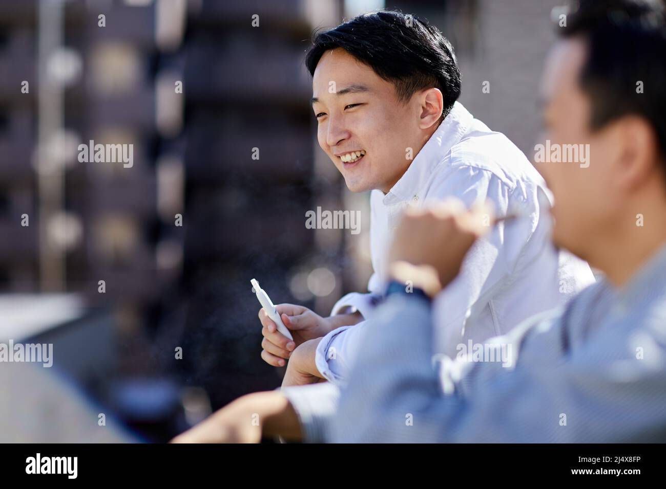 Japanese men smoking outside Stock Photo - Alamy